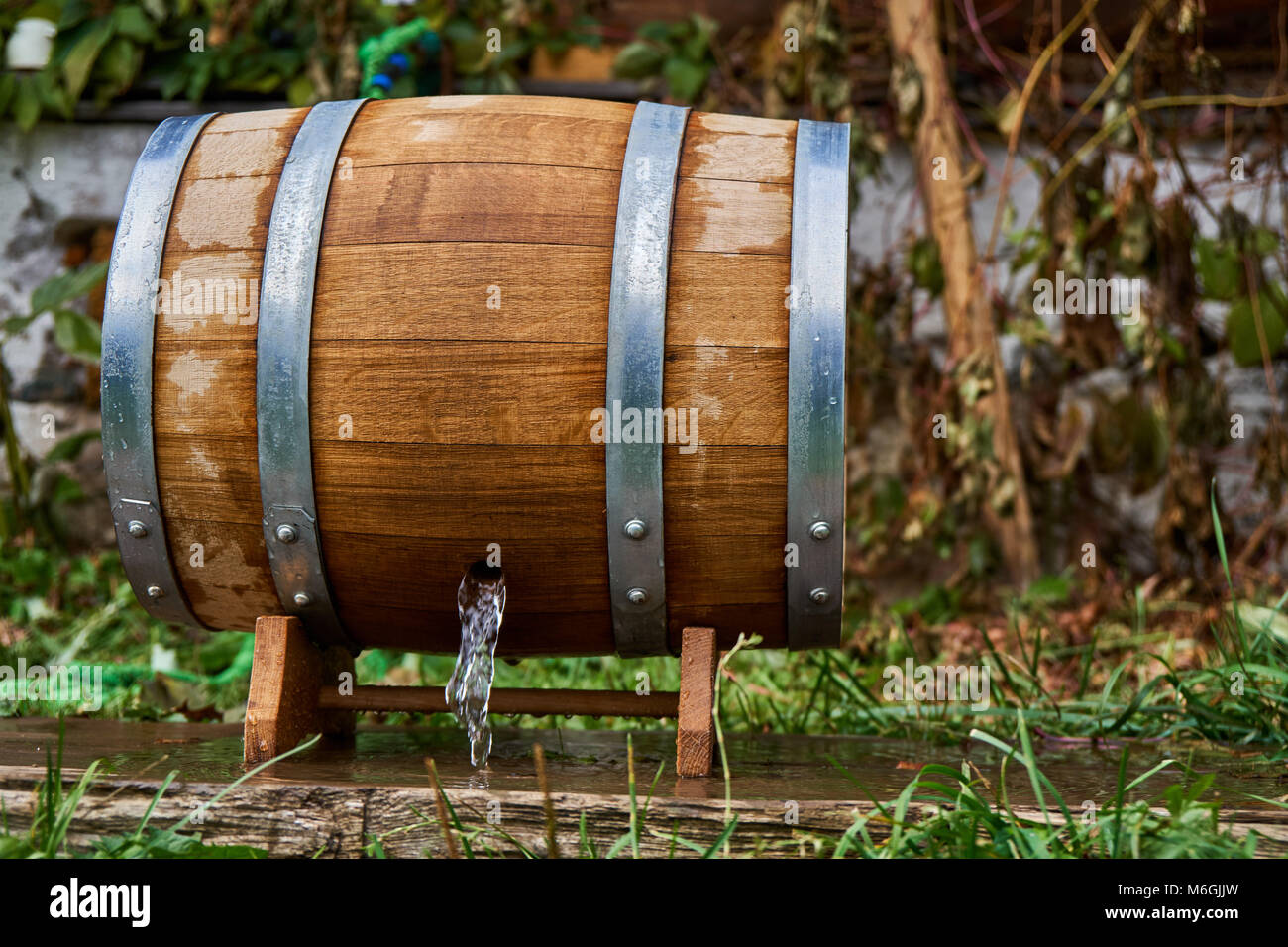 Old oak barrel for storing wine stands on a special stand during ...