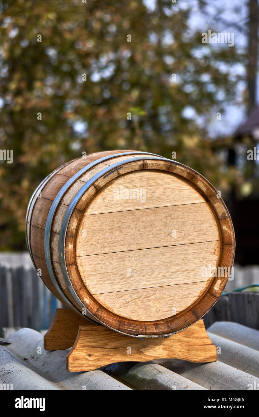 Old oak barrel for storing wine stands on a special stand in the ...