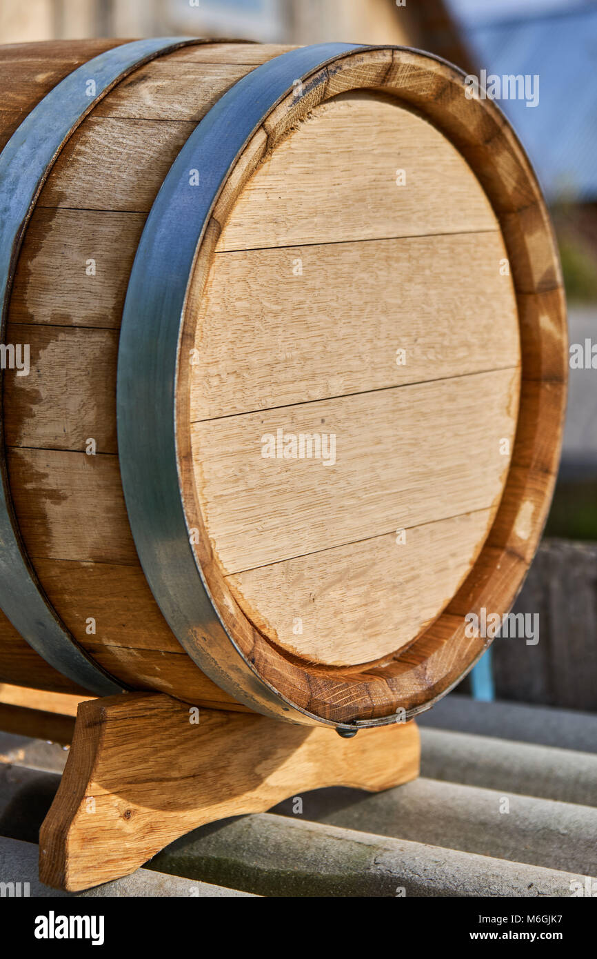 Old oak barrel for storing wine stands on a special stand in the ...