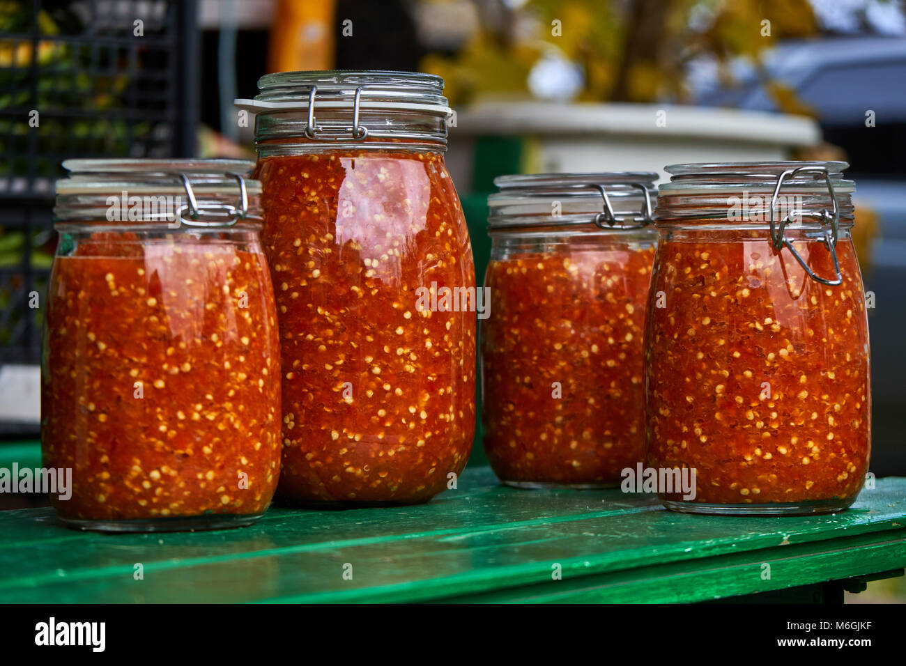Canning the hot pepper. Glass jars with hot pepper. Grinded hot cayenne ...