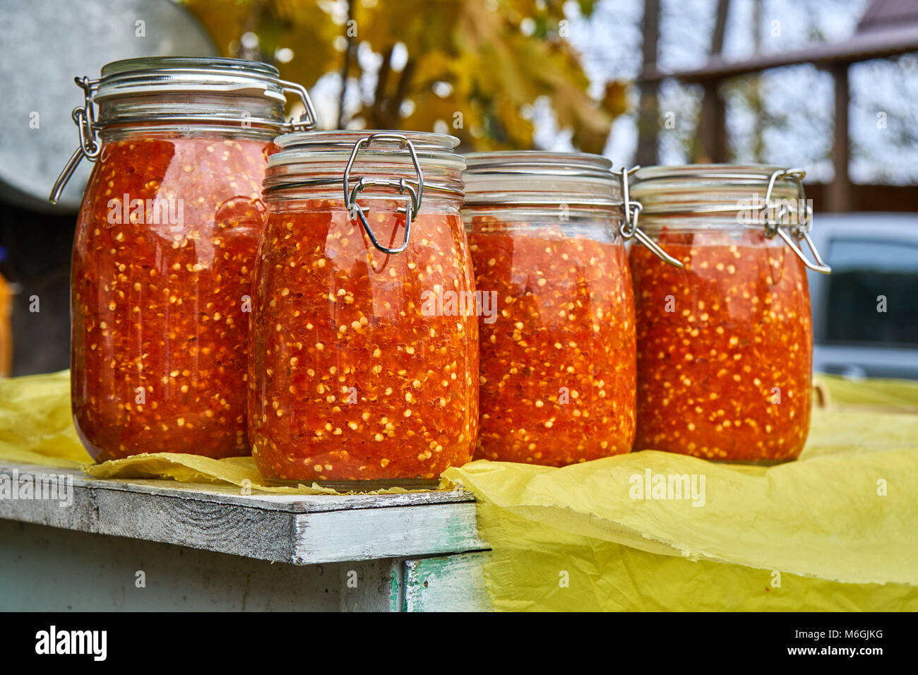 Canning the hot pepper. Glass jars with hot pepper. Grinded hot cayenne ...