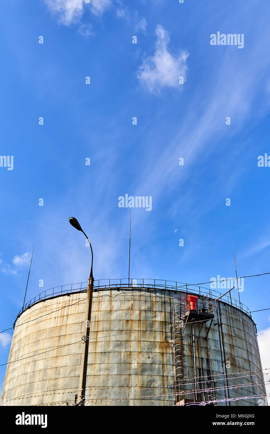 Old rusty industrial fuel storage tank against blue cloudy sky Stock ...