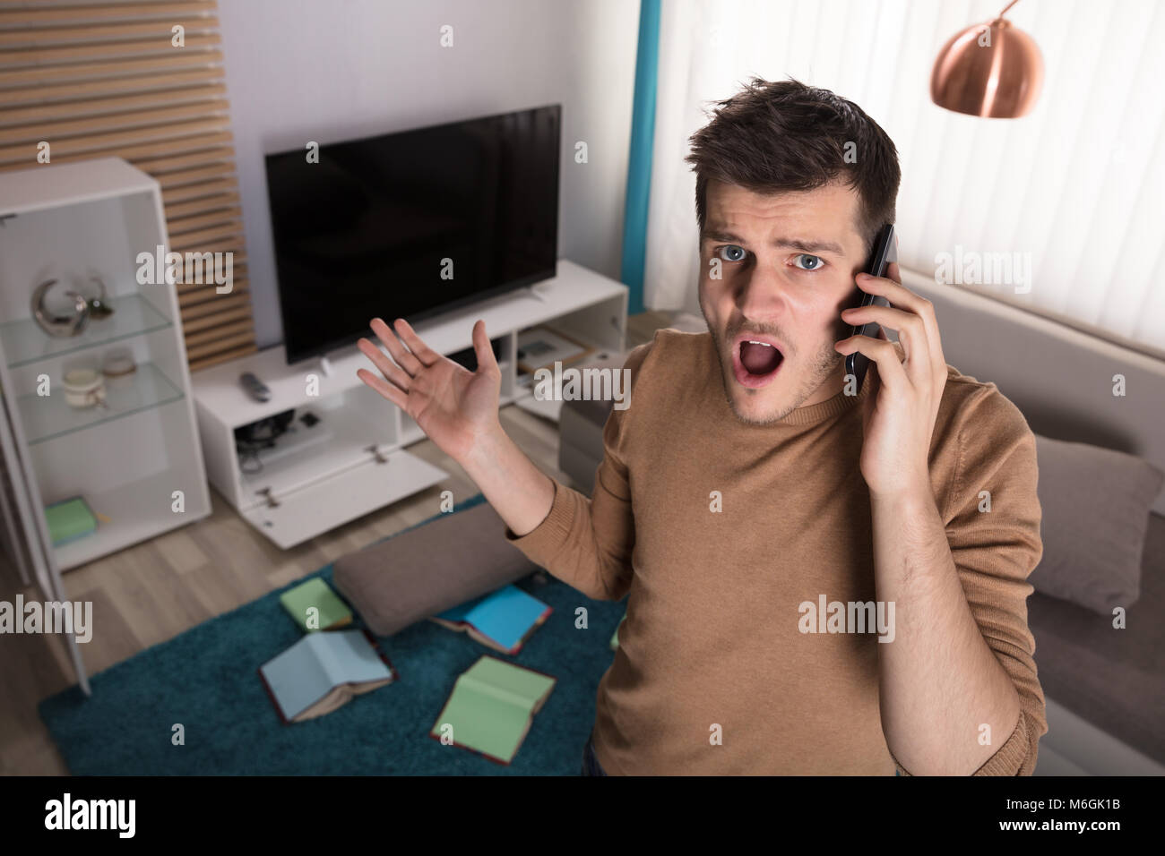 Male talking on phone and pointing hi-res stock photography and images ...
