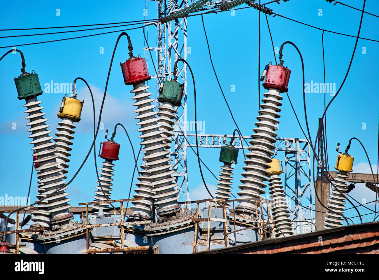 High-voltage insulators on transformer substation against blue sky ...