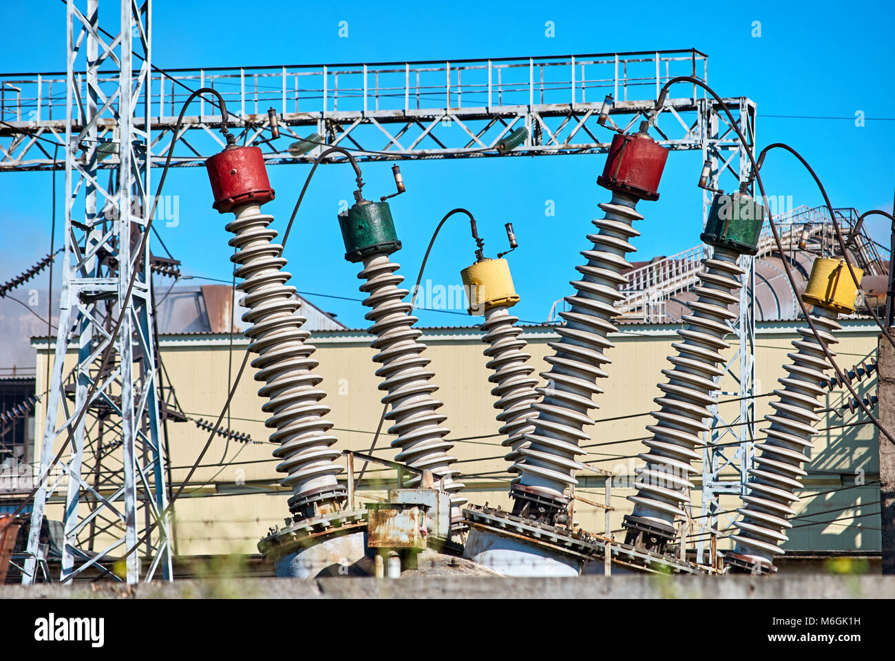 High-voltage insulators on transformer substation against blue sky ...