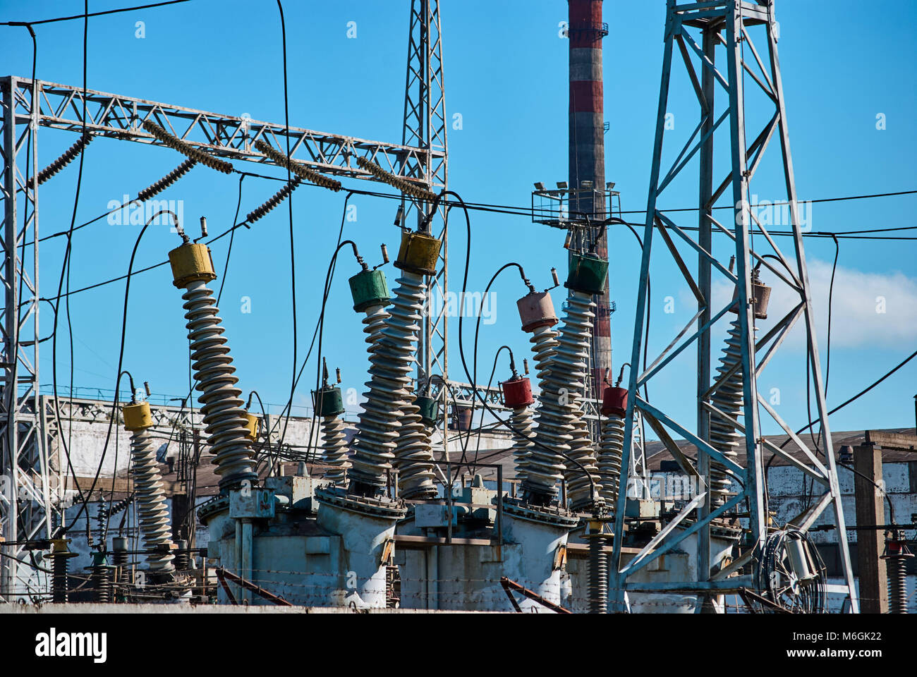 High-voltage insulators on transformer substation against blue sky ...