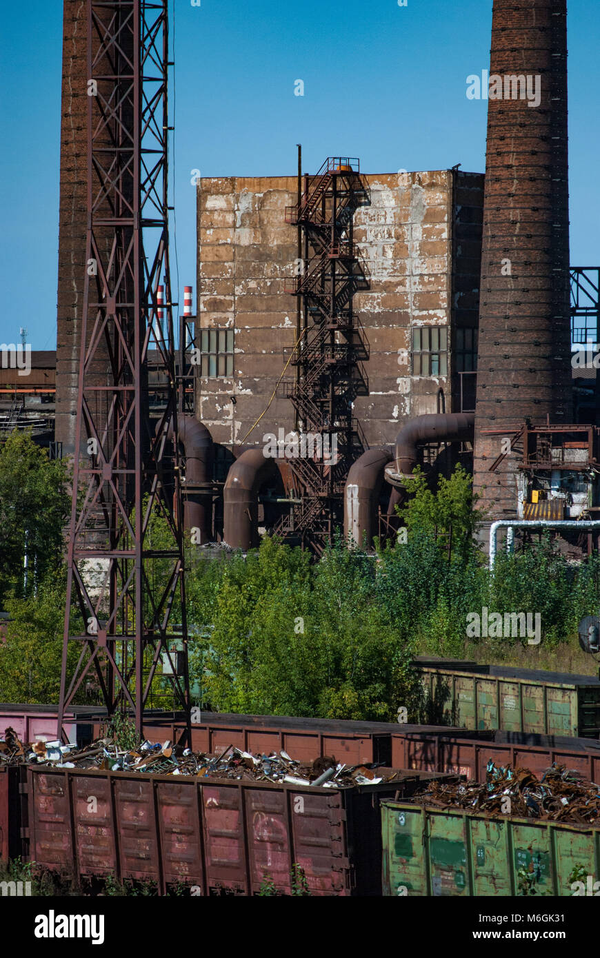 Abandoned industrial complex, with tall, weathered smokestacks towering ...