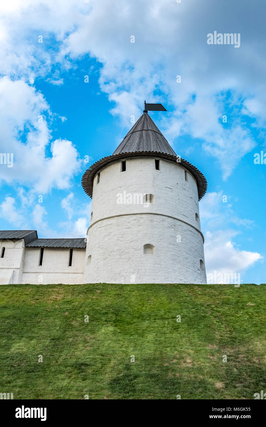 Majestic white medieval fortress tower with a conical roof atop a ...