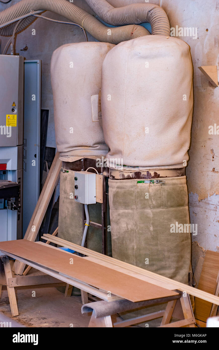 Dust extraction system in a woodworking shop with flexible hose ...