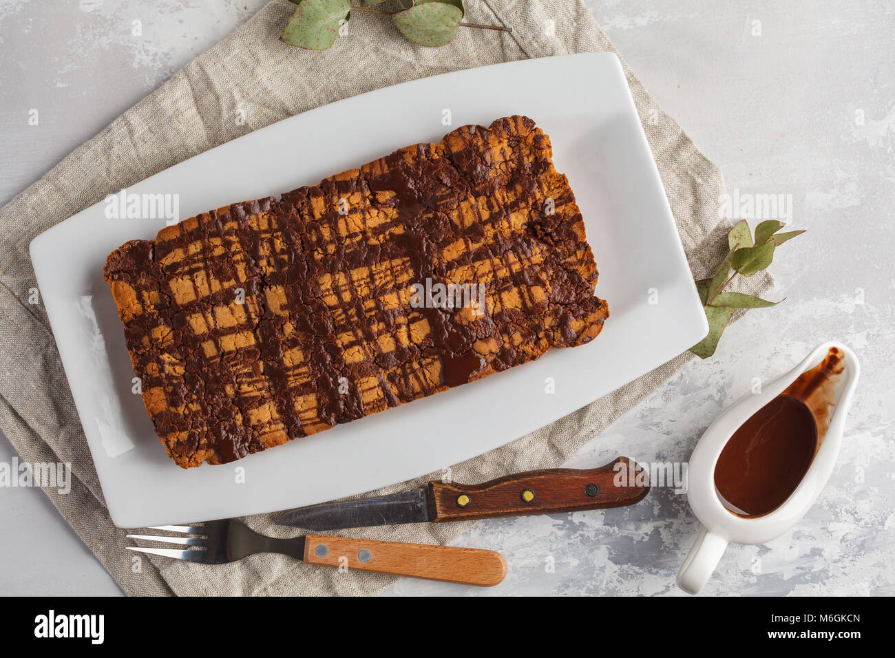 Vanilla vegan aquafaba cake with chocolate glaze in a white dish Stock ...