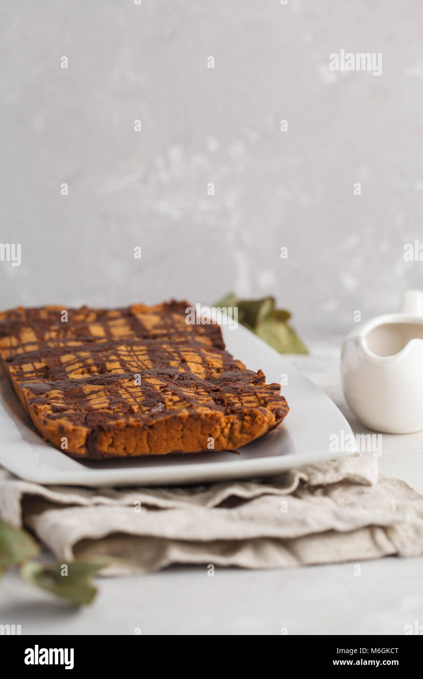 Vanilla vegan aquafaba cake with chocolate glaze in a white dish Stock ...