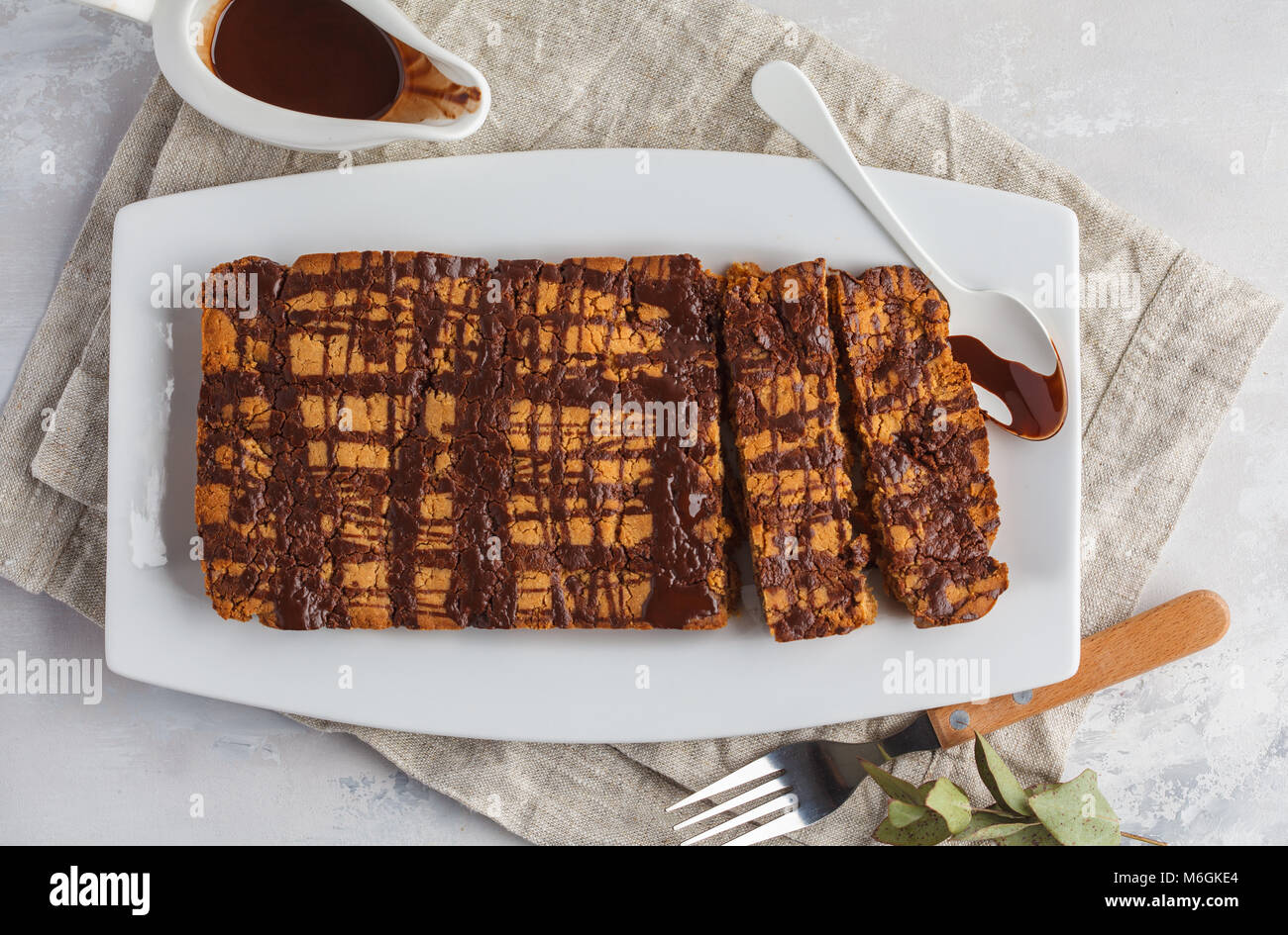 Vanilla vegan aquafaba cake with chocolate glaze in a white dish Stock ...