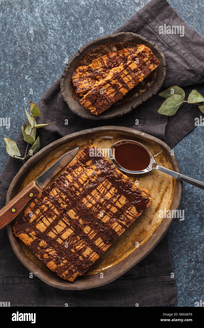 Vanilla vegan aquafaba cake with chocolate glaze in a dark dish Stock ...