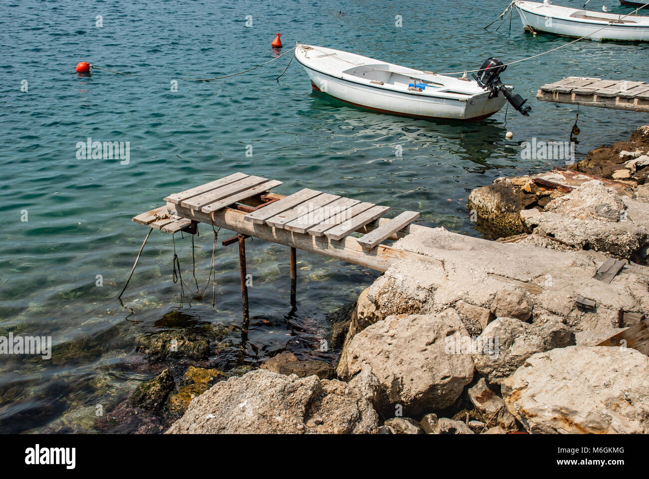 Remains of small piers and rough cement blocks located on shore near ...