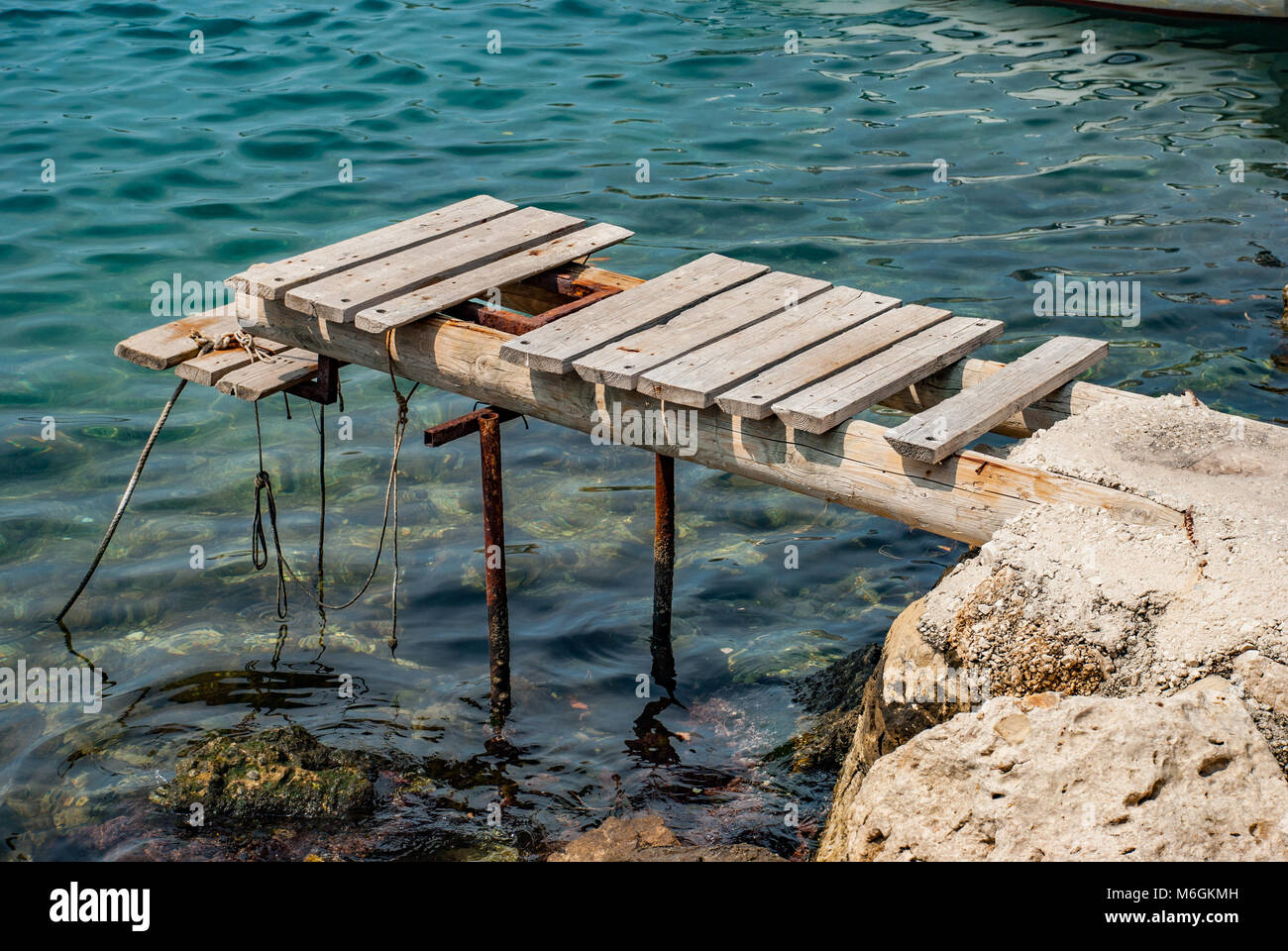 Remains of small piers and rough cement blocks located on shore near ...