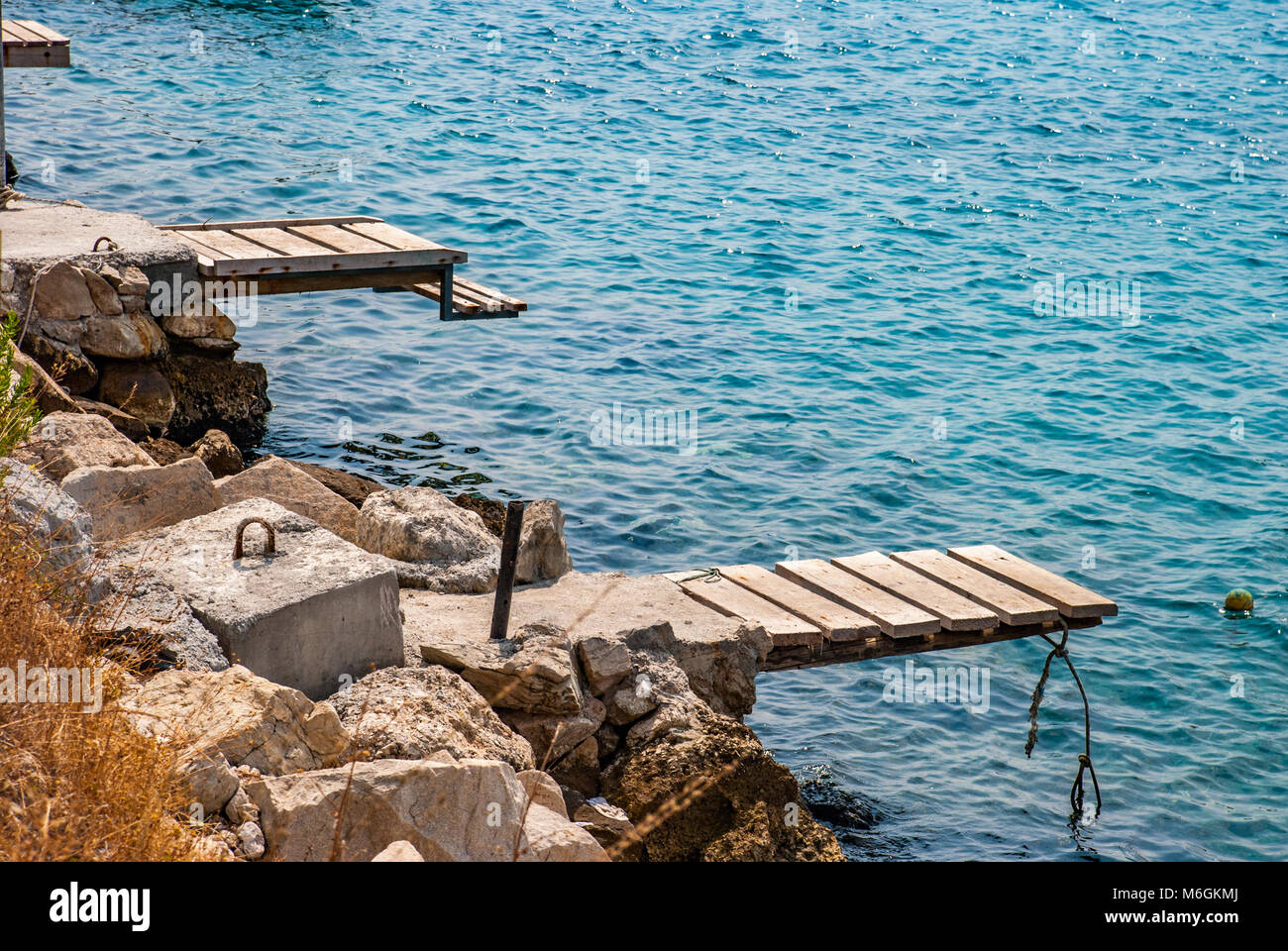 Remains of small piers and rough cement blocks located on shore near ...