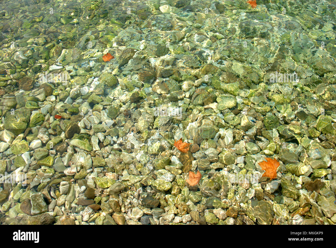 Crystal clear sea waters at a pebble beach close-up. Omis, Dalmatia ...