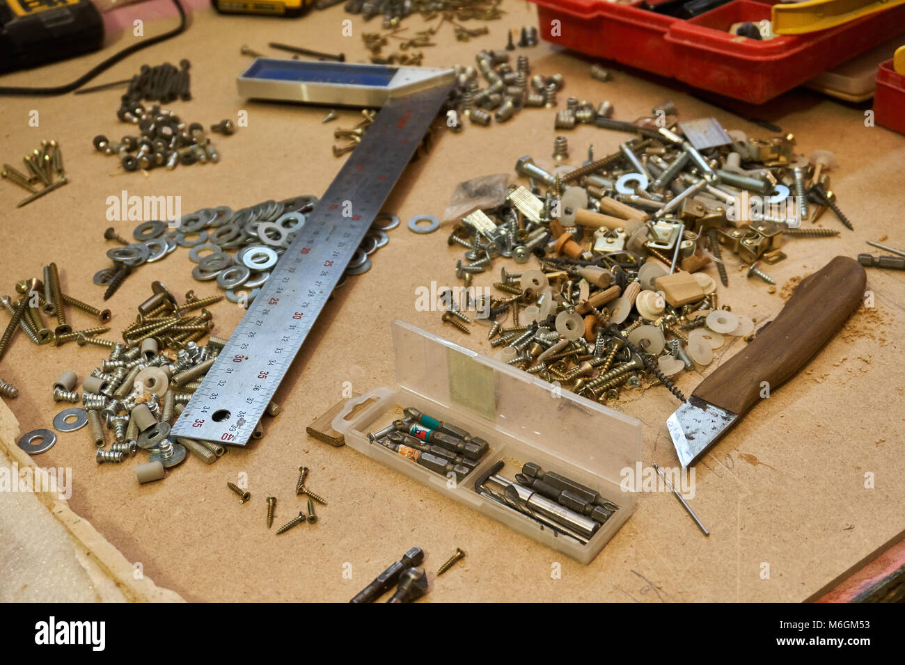 Workbench with various tools and equipment scattered on it, including a ...