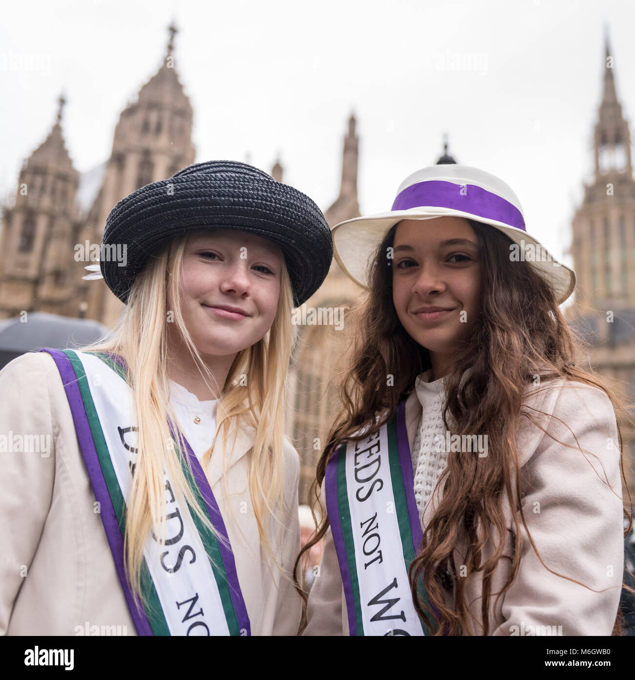London, UK. 4 March 2018. Girls dressed as suffragettes join the march ...