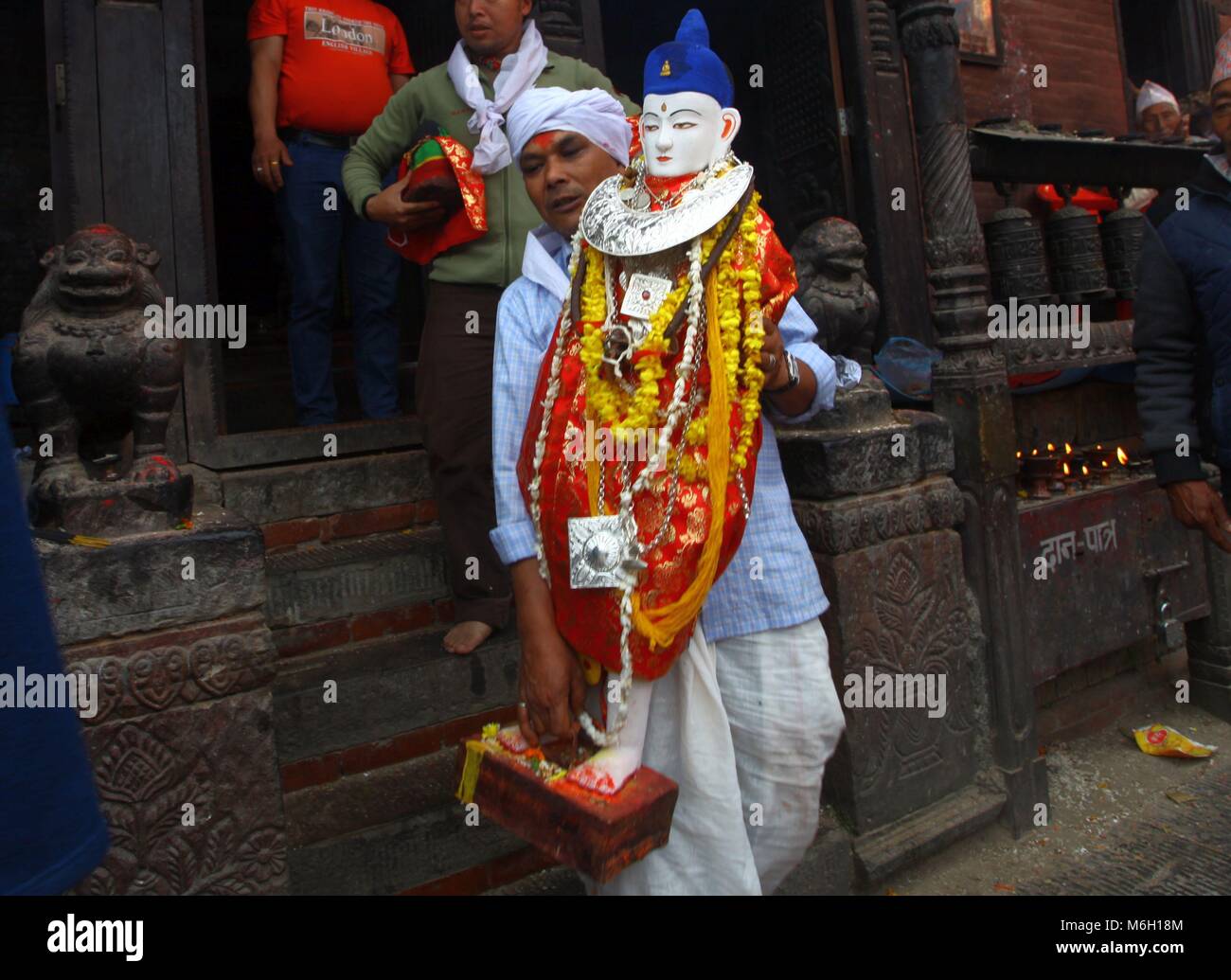 Kavre, Nepal's capital Kathmandu. 4th Mar, 2018. A priest carries a ...