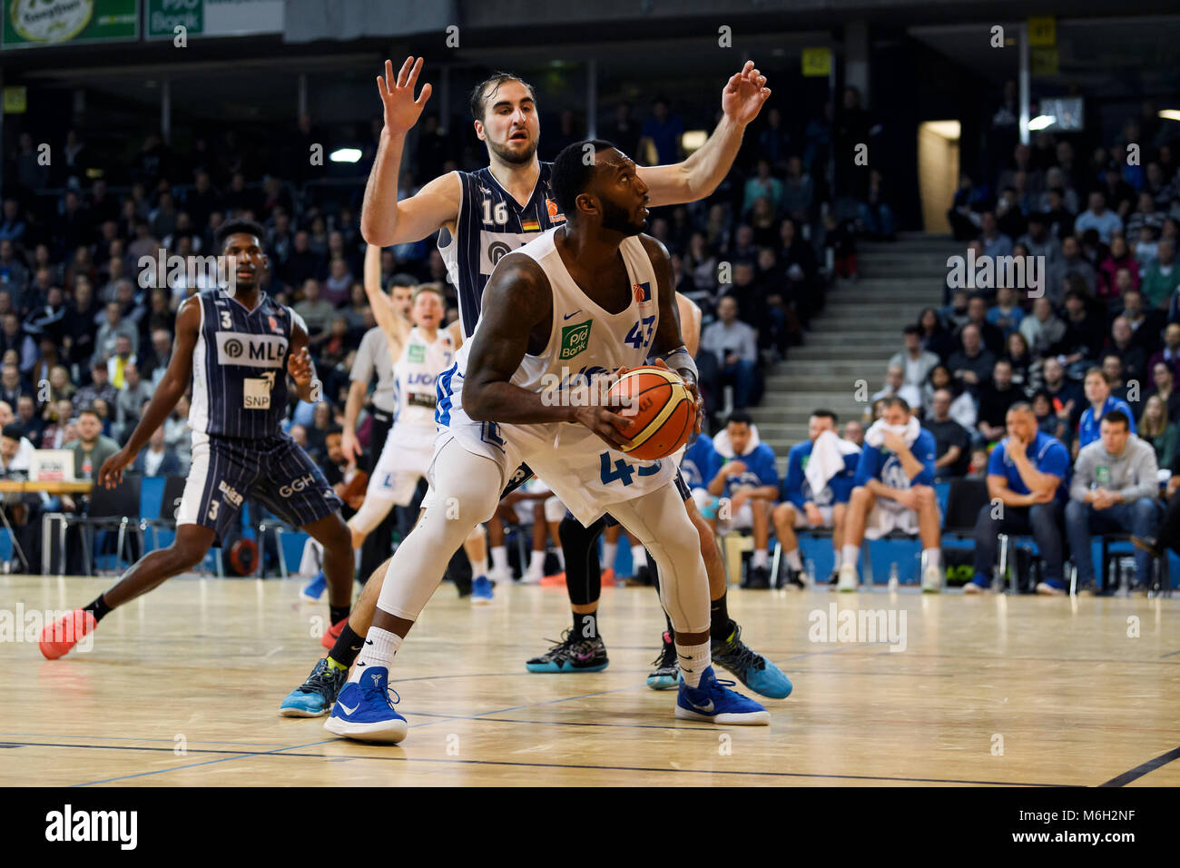 Karlsruhe, Deutschland. 04th Mar, 2018. Cyrus Lamont Tate (Lions Karlsruhe) im duels with Niklas ...