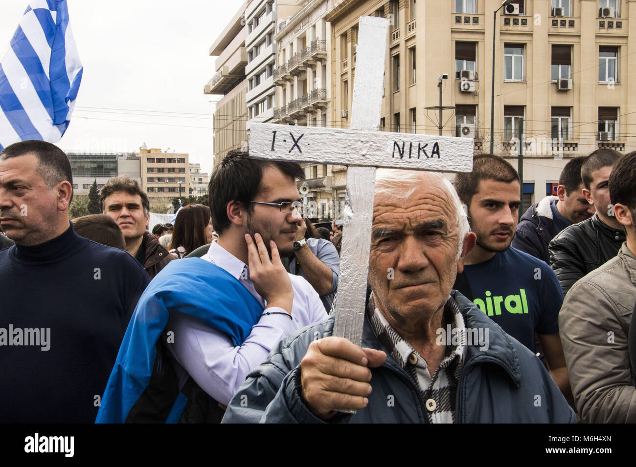Athens, Greece. 4th Mar, 2018. A male protester seen with a cross ...