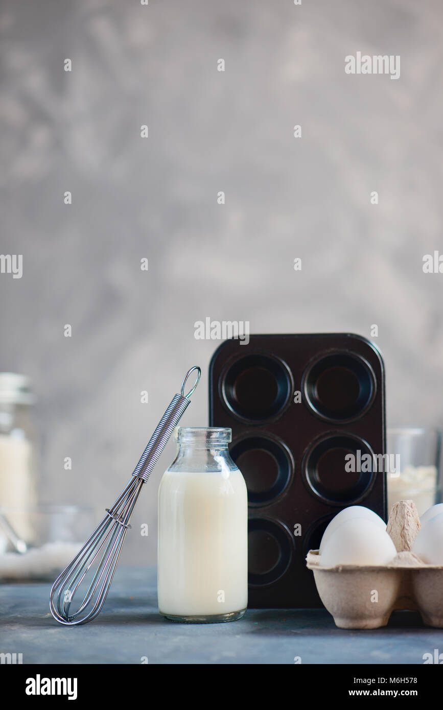 Baking tools and ingredients on a concrete background. High key food ...