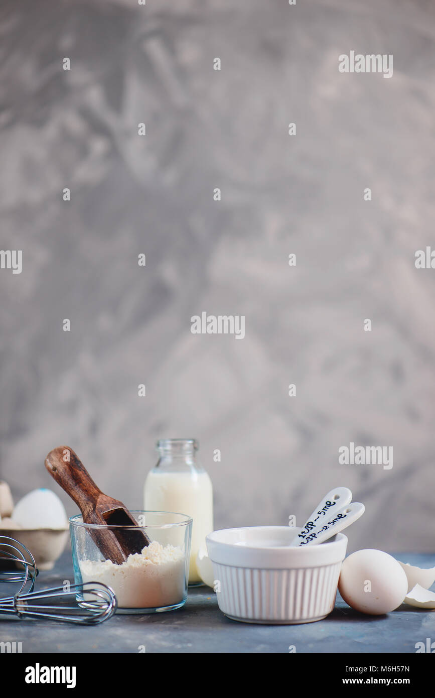 Baking tools and ingredients concept in high key. Baking forms, whisk ...
