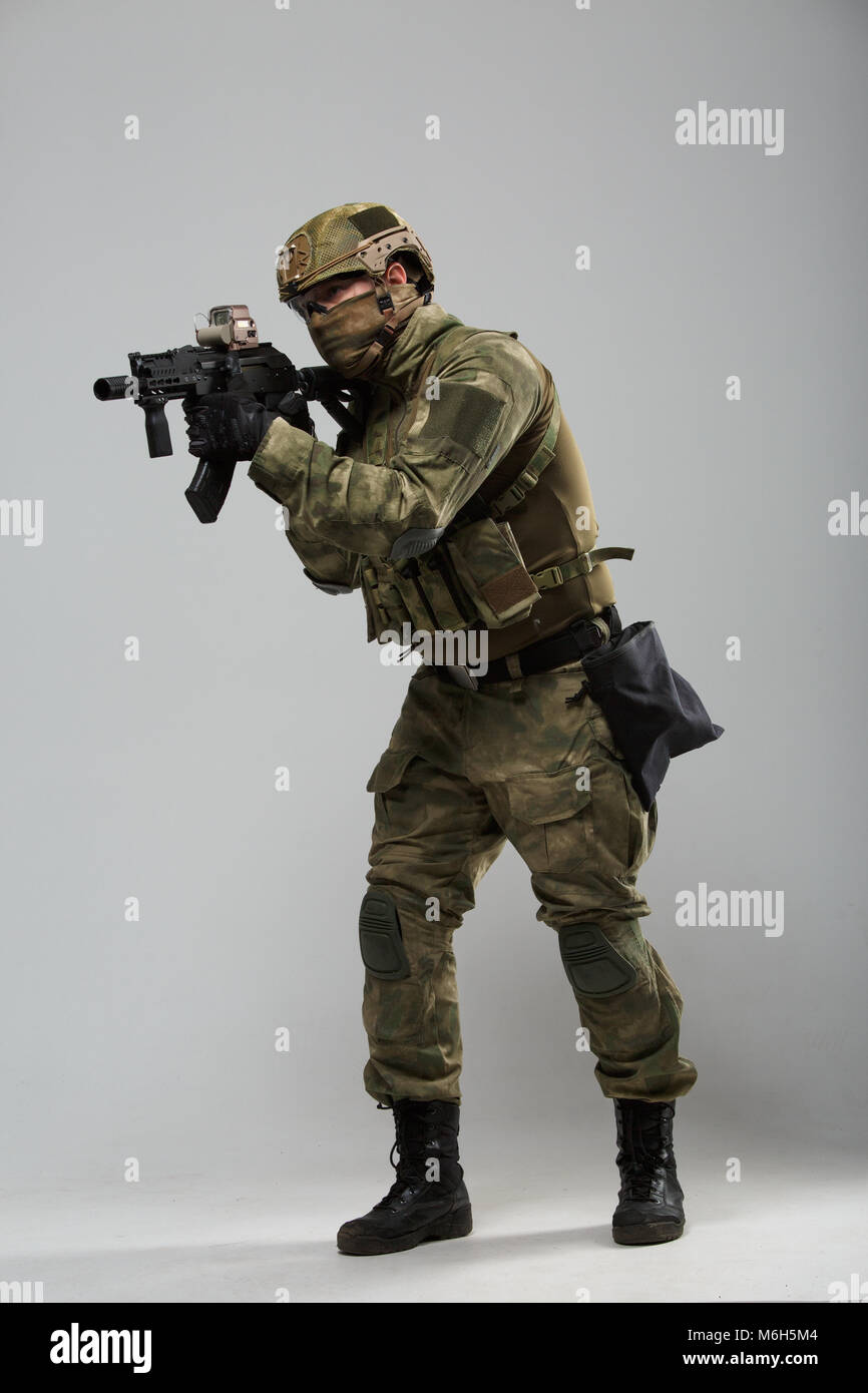 Portrait of full-length military man in camouflage with gun Stock Photo ...