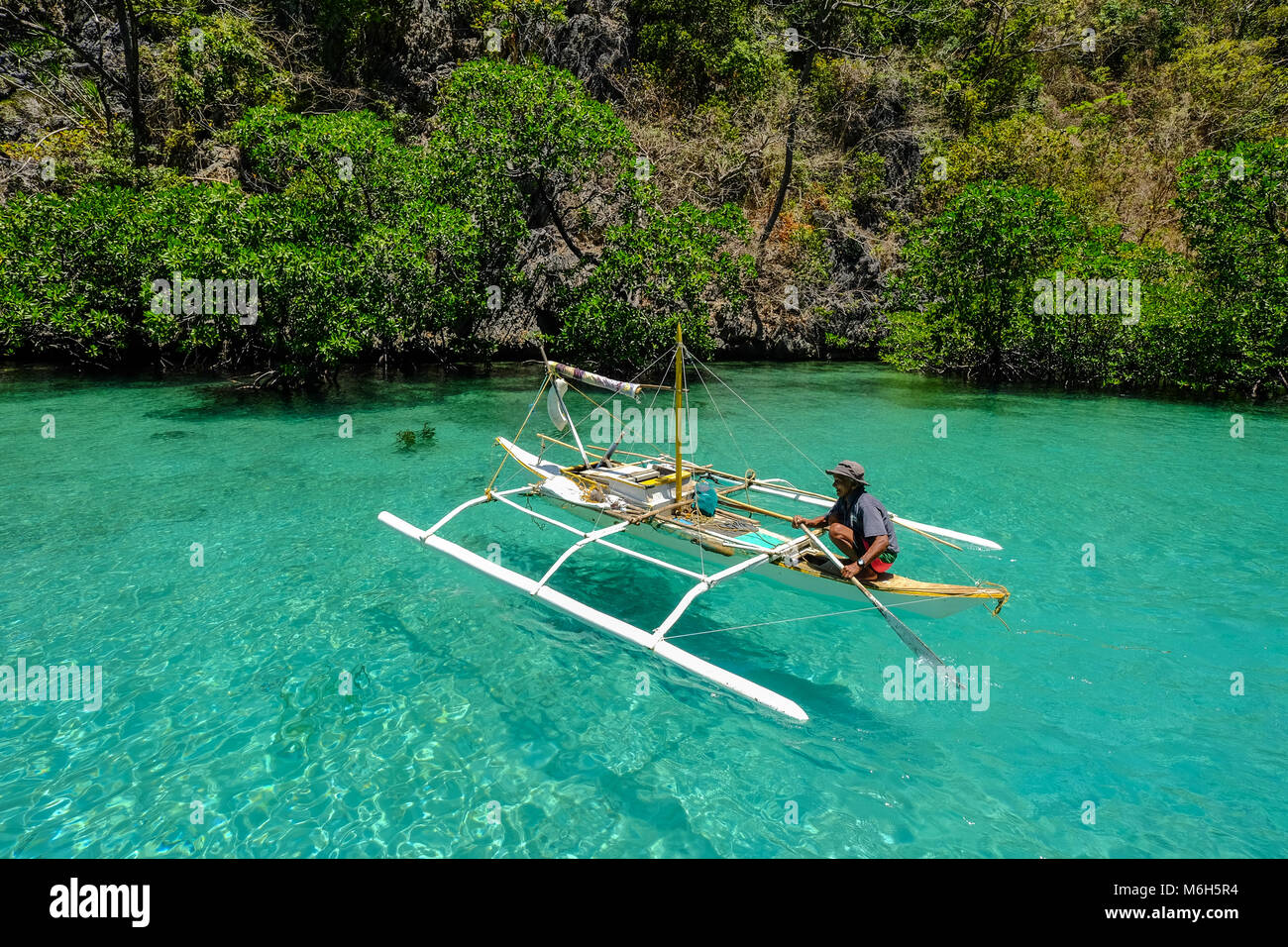 Coron, Philippines - Apr 10, 2017. A man sitting on boat in Coron ...
