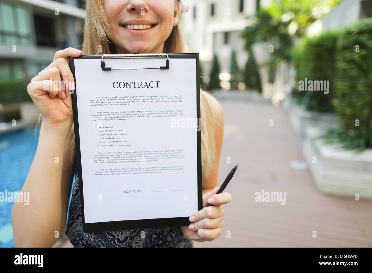 young woman offer to sign contract document on background of new Stock ...