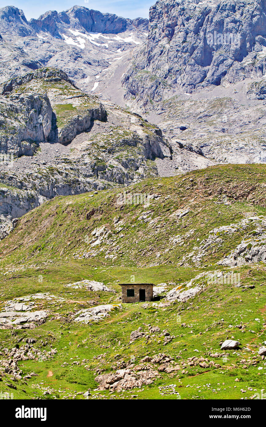 The small stone hut in mountains. Around a lodge the stones covered ...
