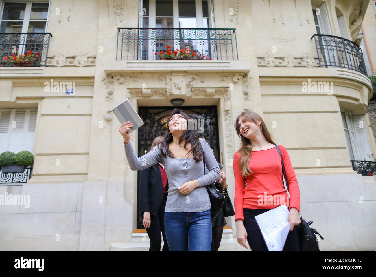 Happy students leaving university building in Stock Photo - Alamy