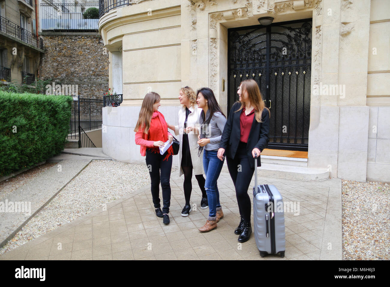 Happy students leaving university building in Stock Photo - Alamy