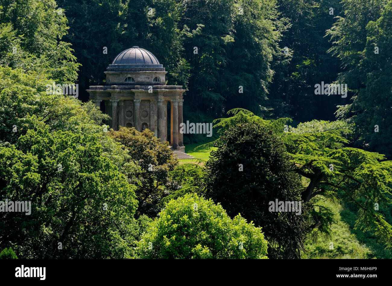 The Temple of Apollo amongst the trees at Stourhead Garden Stock Photo ...