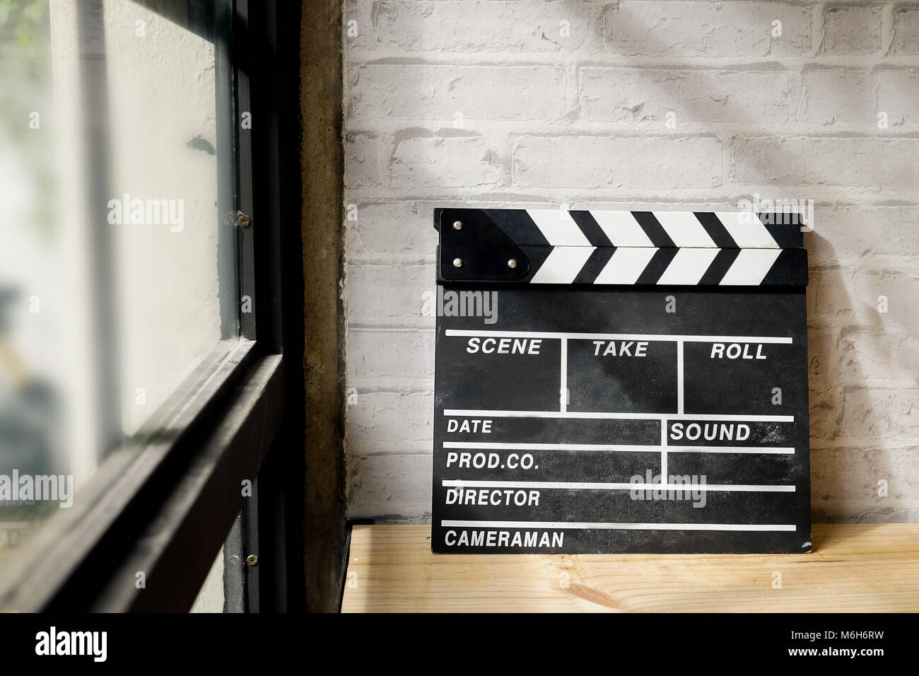 movie clapper on wood desk with windows light Stock Photo - Alamy