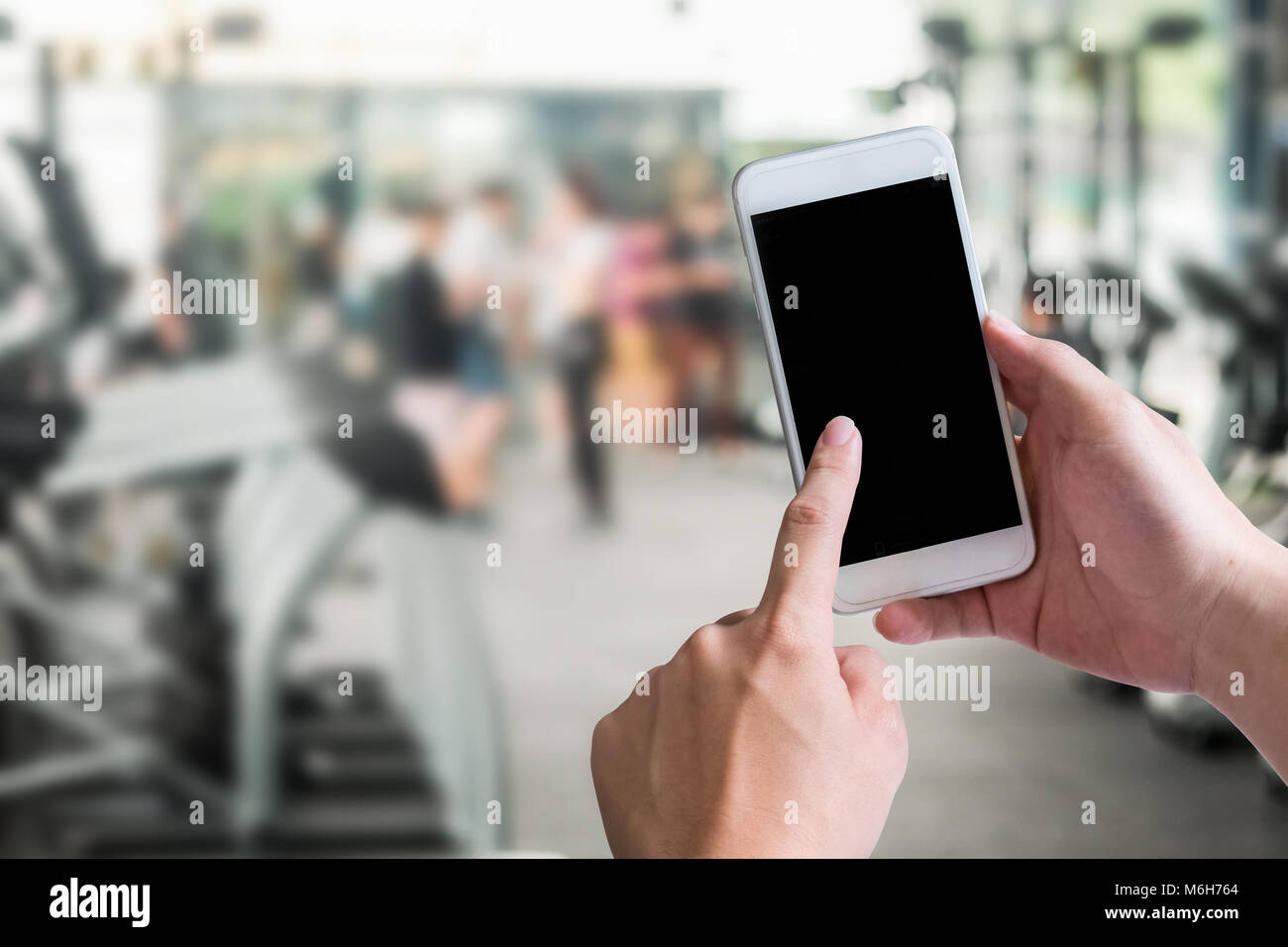 Smartphone device on fitness blur background with empty screen display ...