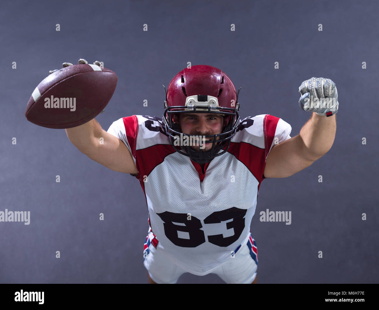 american football player celebrating touchdown isolated on gray ...