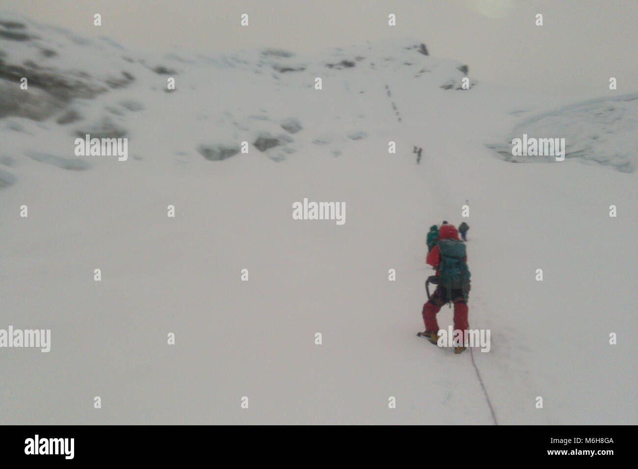 Picture of a group of climbers climbing with ropes in line, Island Peak ...