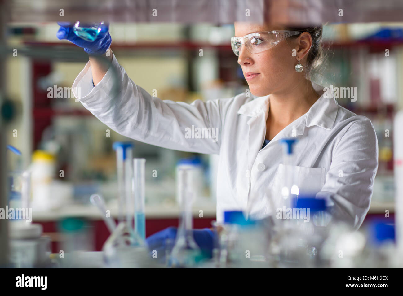 Female researcher carrying out scientific research in a lab (shallow ...