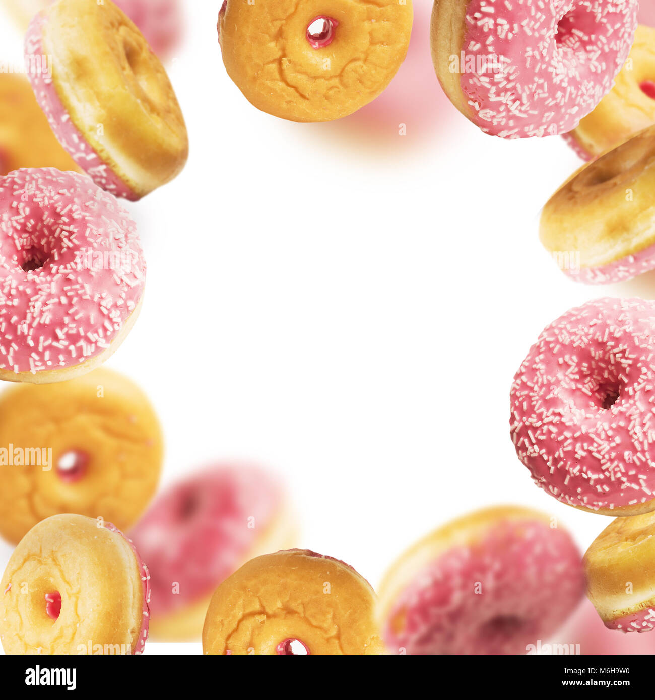 Falling or flying pink glazed doughnuts with sprinkles in motion at ...