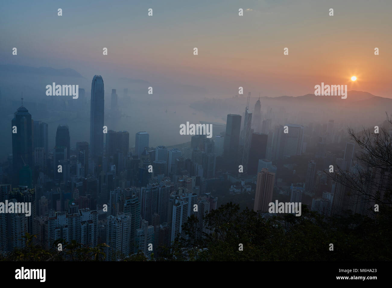Sun Rising Over The Hong Kong Skyline, Viewed From The Peak Stock Photo ...