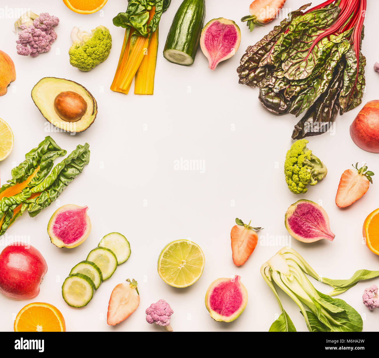 Various healthy fruits and vegetables ingredients frame on white desk ...