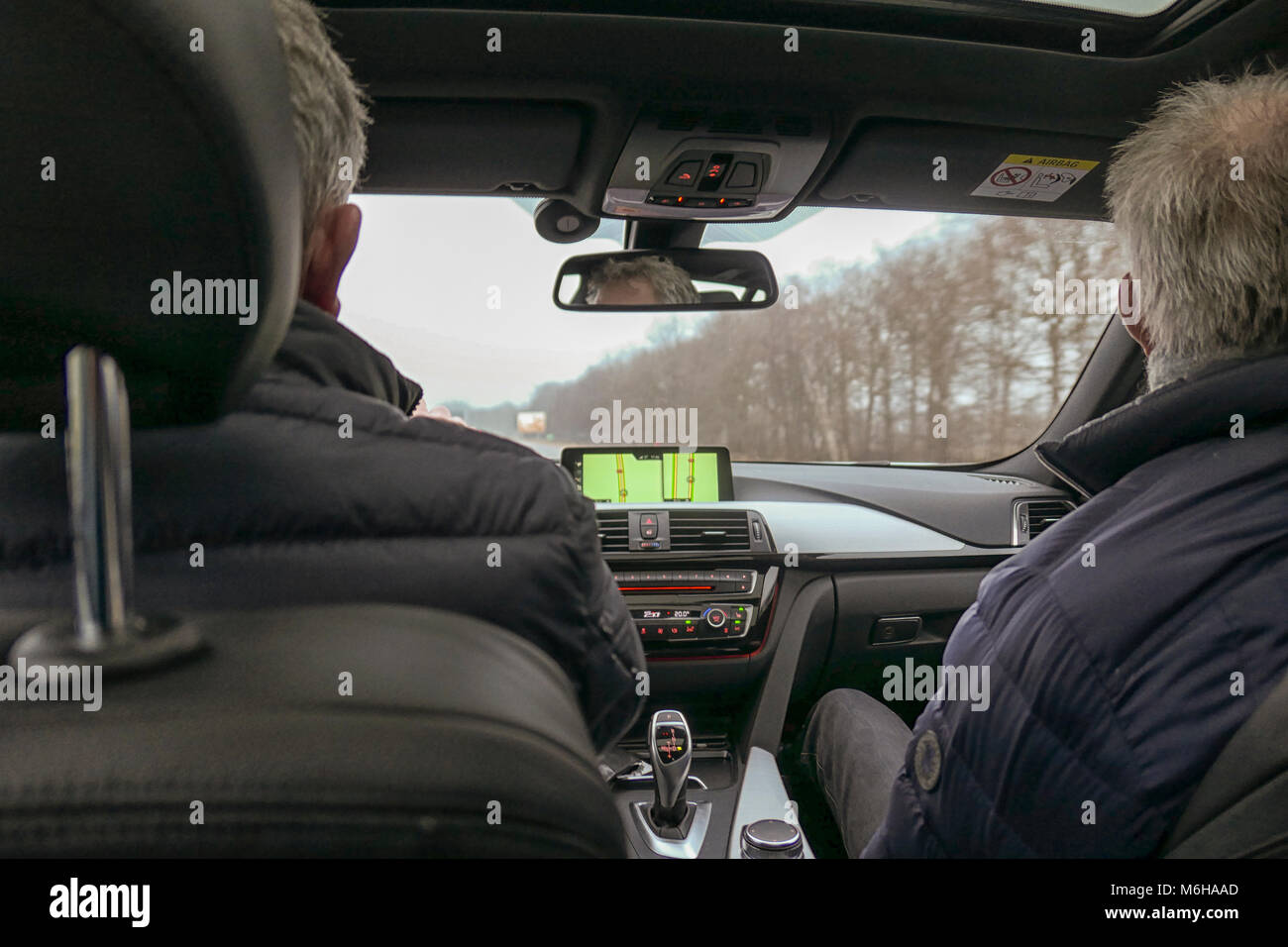 Two men inside car driving on highway Stock Photo - Alamy