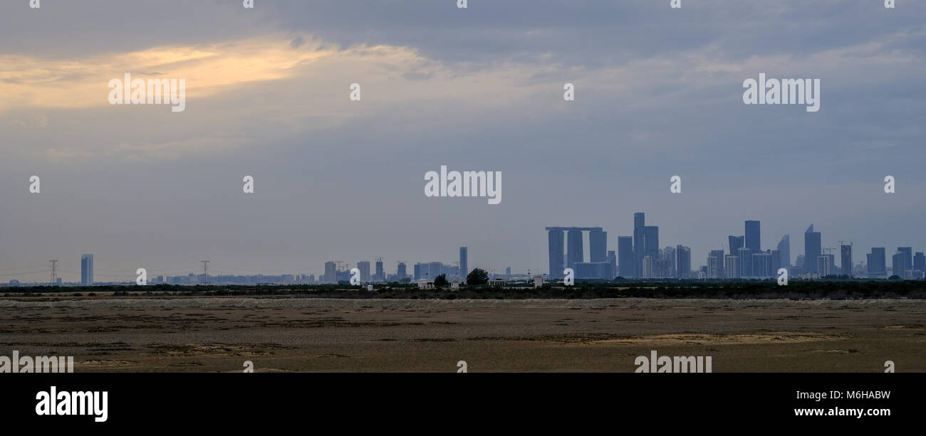 Abu Dhabi city skyscrapers from distance covered with clouds Stock ...