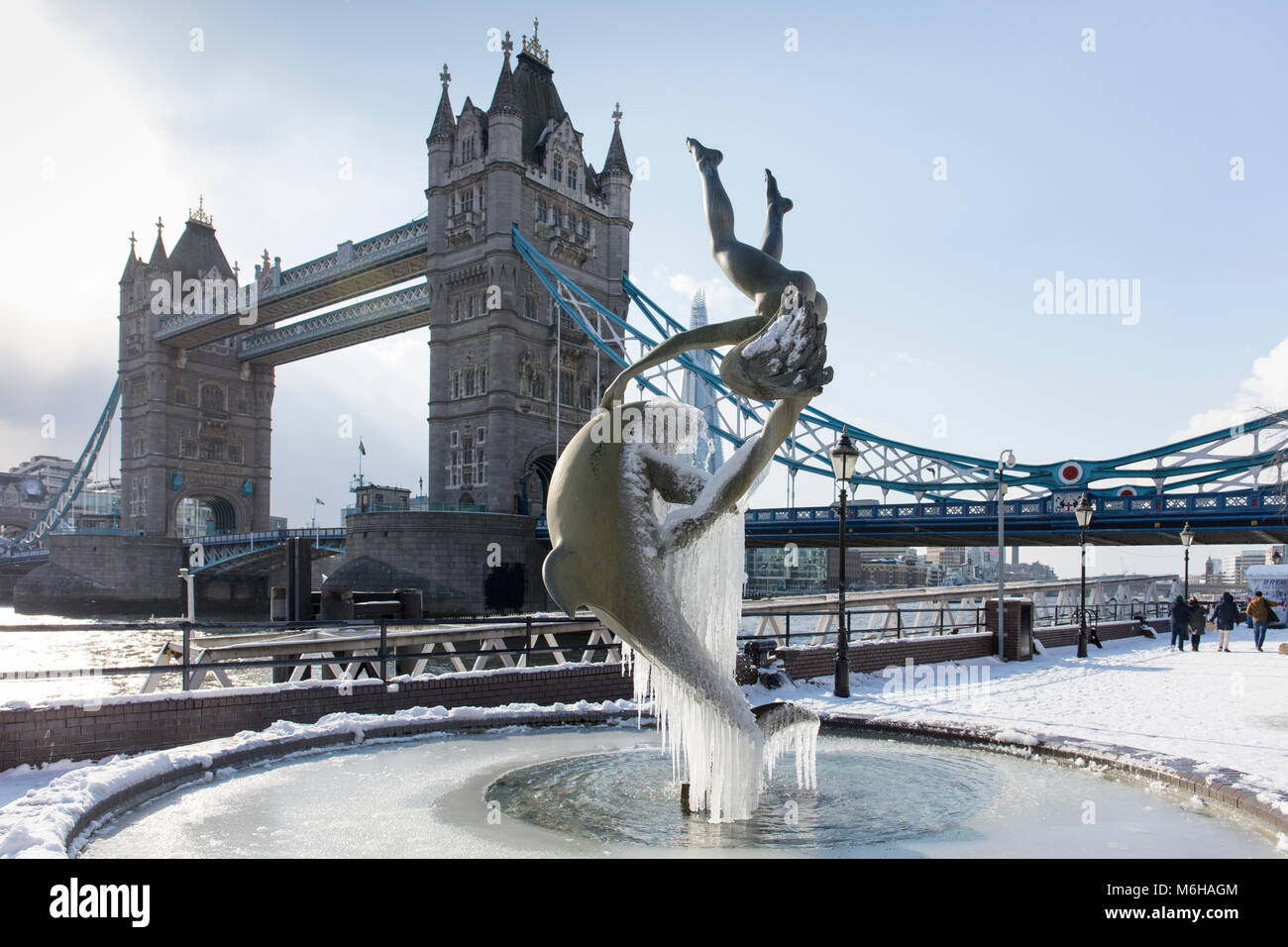Tower Bridge and a frozen Dolphin and Mermaid statue, London in the ...