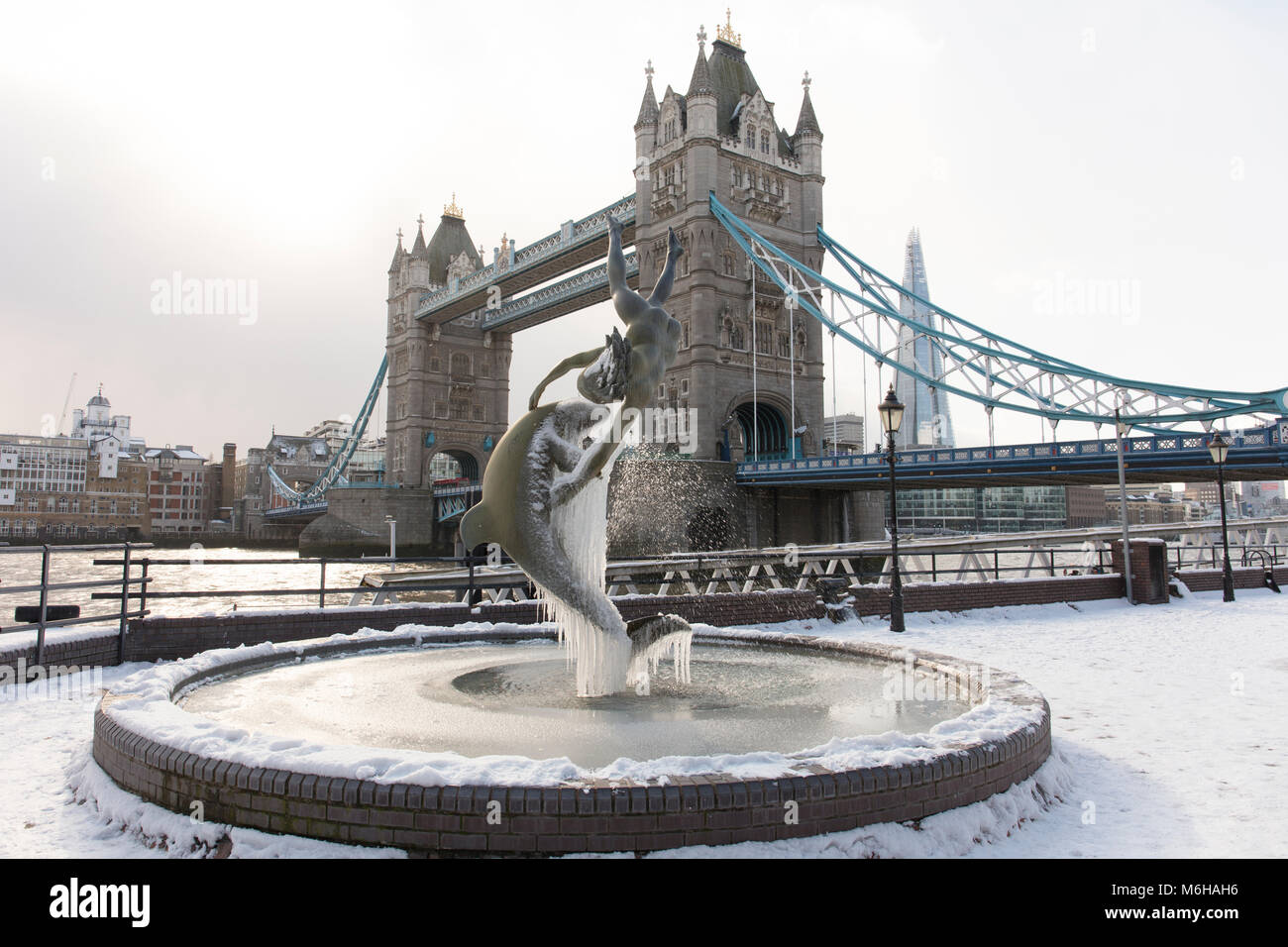 Tower Bridge and a frozen Dolphin and Mermaid statue, London in the ...