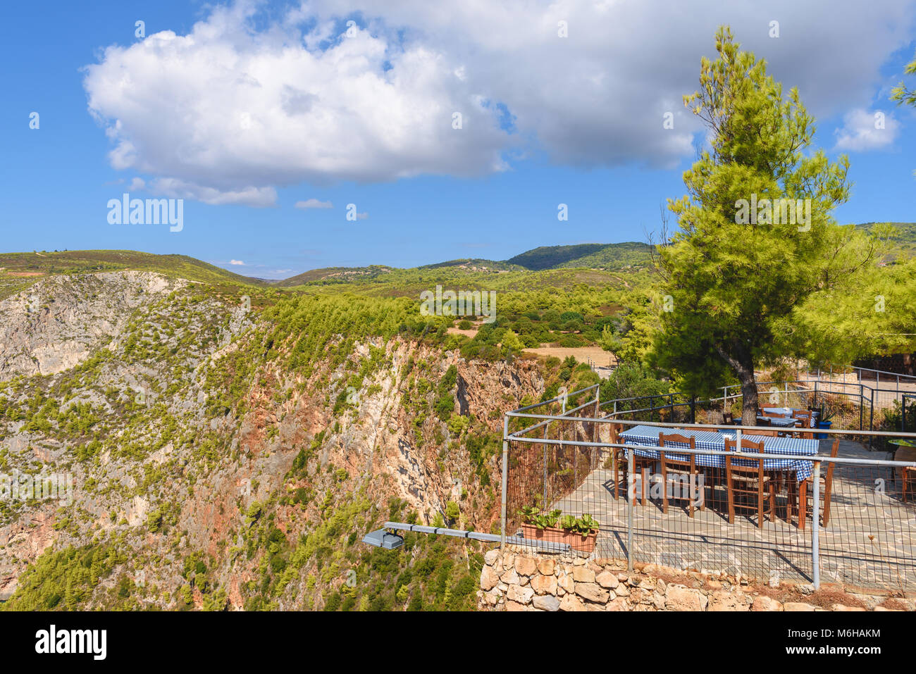 Tables with chairs on terrace of coastal restaurant in Porto Schiza on ...