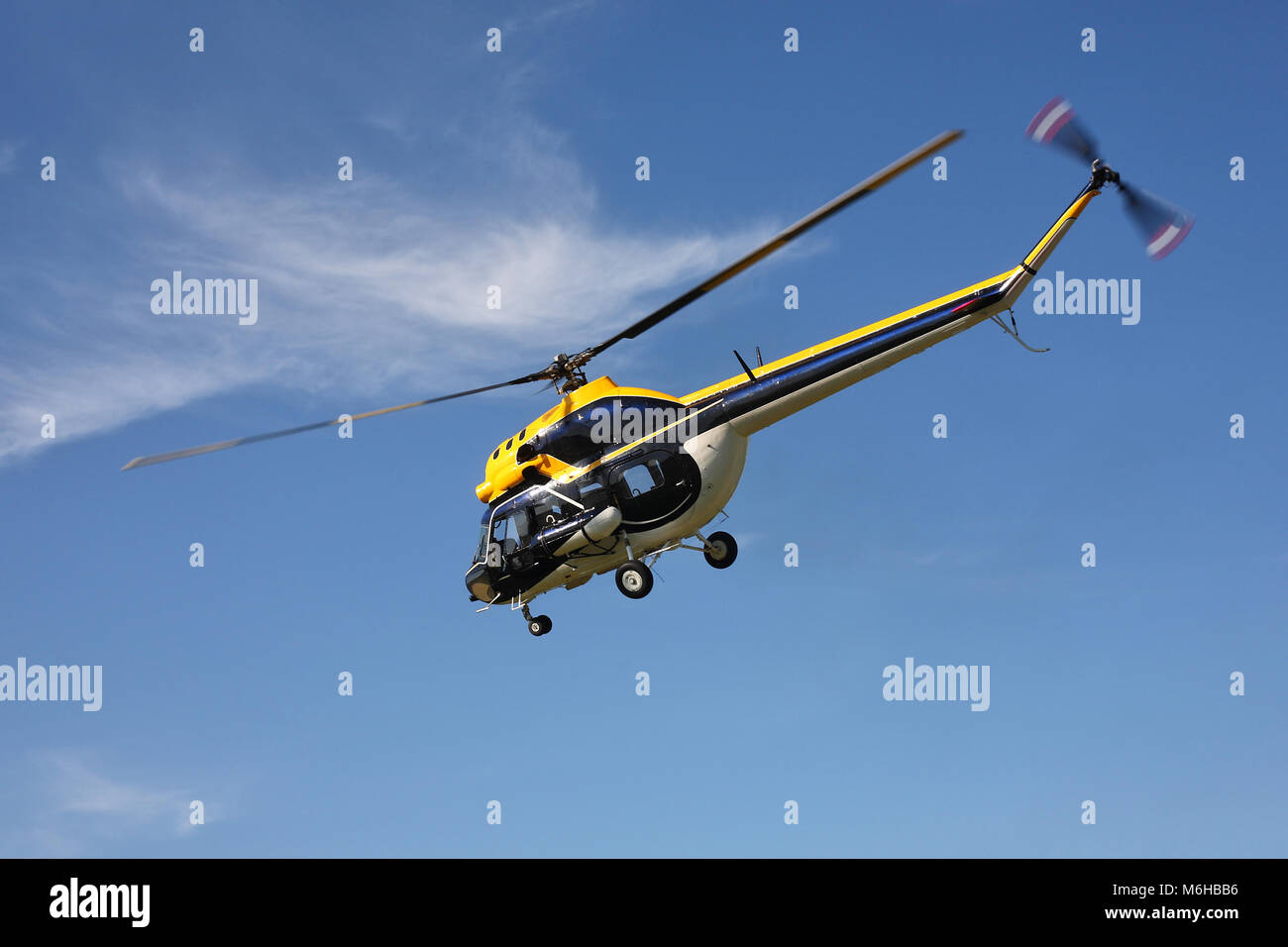 Aircraft - Big black-yellow helicopter at competitions makes flight at ...