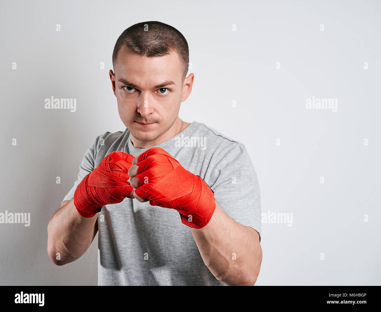 man in red Boxing bandages white background Stock Photo - Alamy